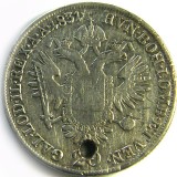 Why do some ancient coins have holes in them?